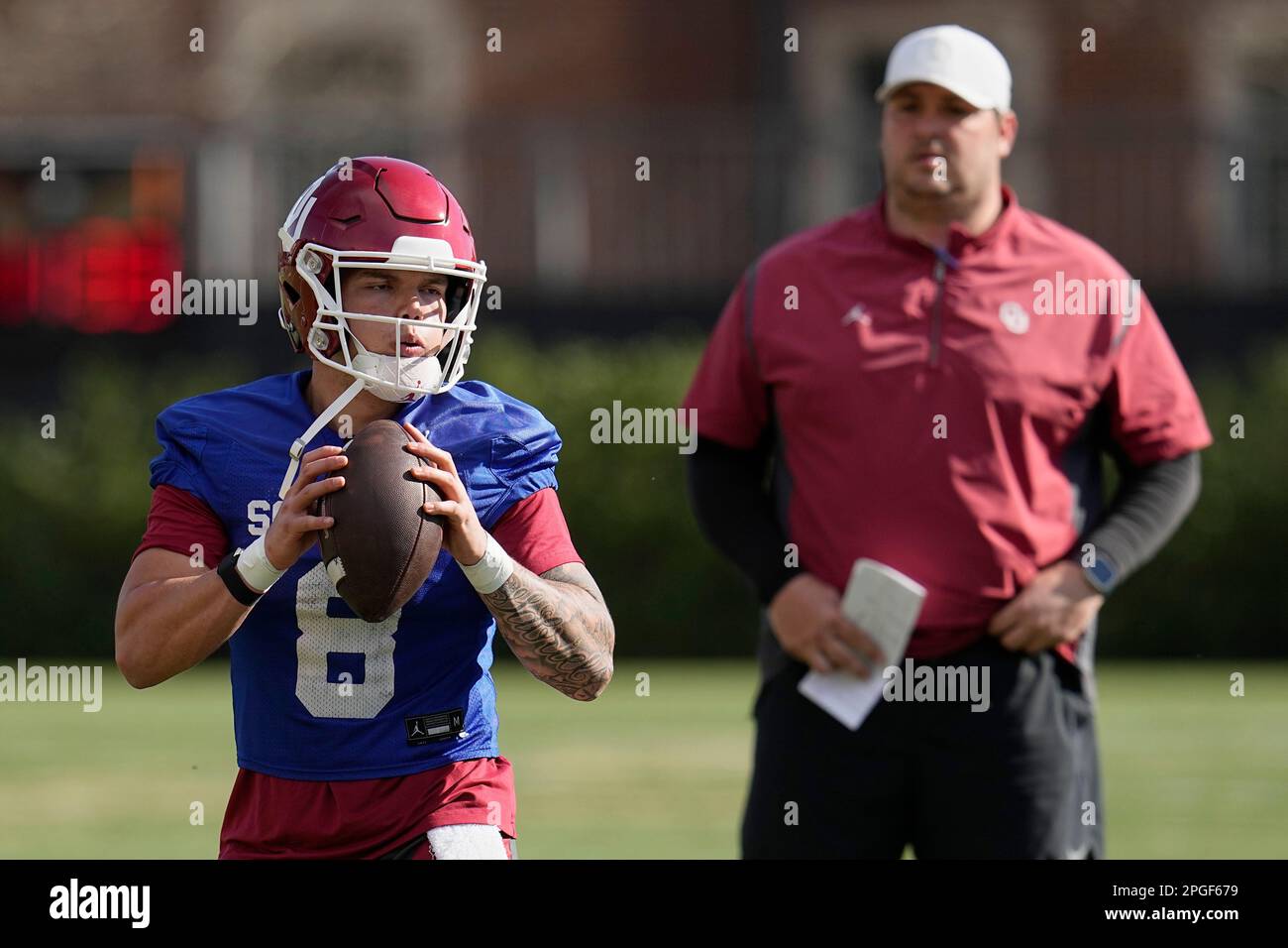 Oklahoma quarterback Dillon Gabriel throws in front of Jeff Lebby, rear ...