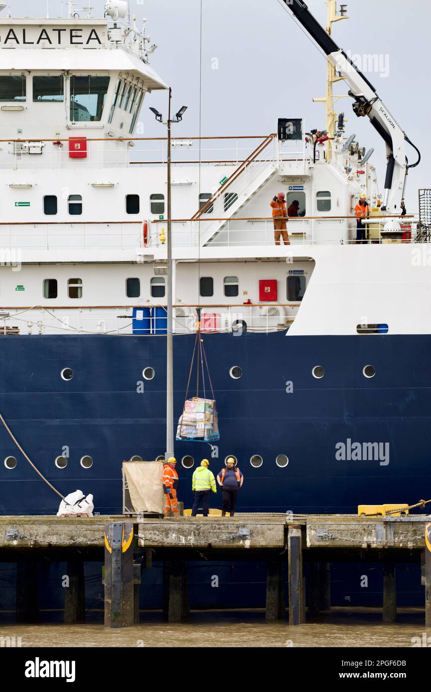 Dock workers and crew from the Trinity House buoy-laying vessel Galatea ...