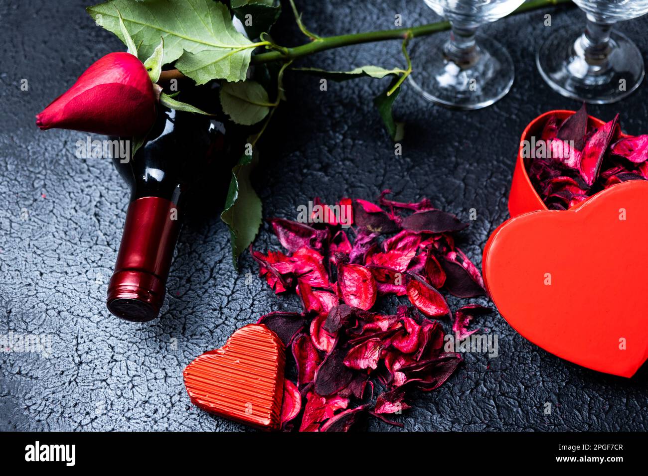 Valentine's day concept. Romantic evening, red wine, red rose, black ...