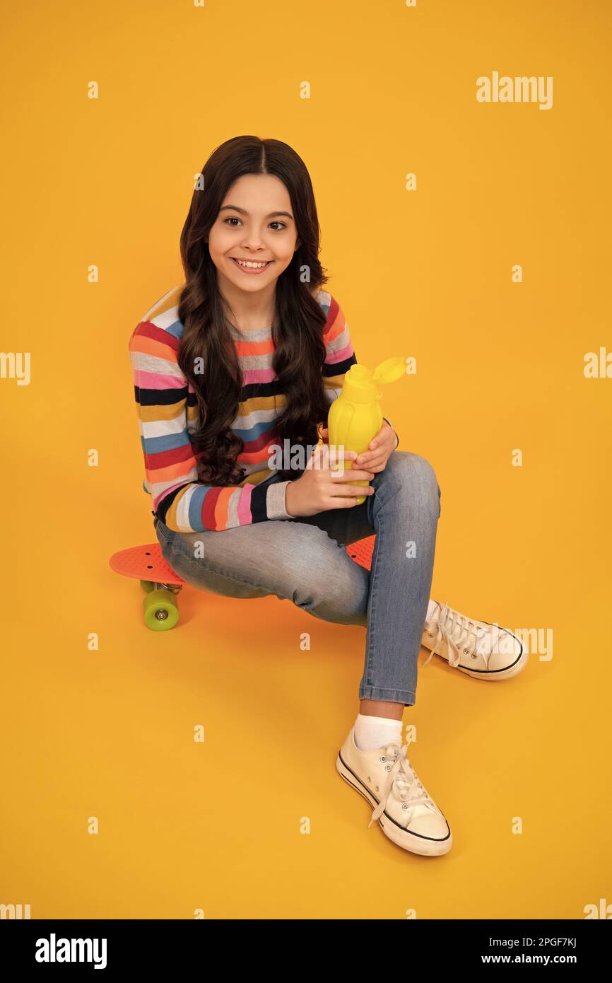 Child 12, 13, 14 years old with water bottle isolated studio background ...