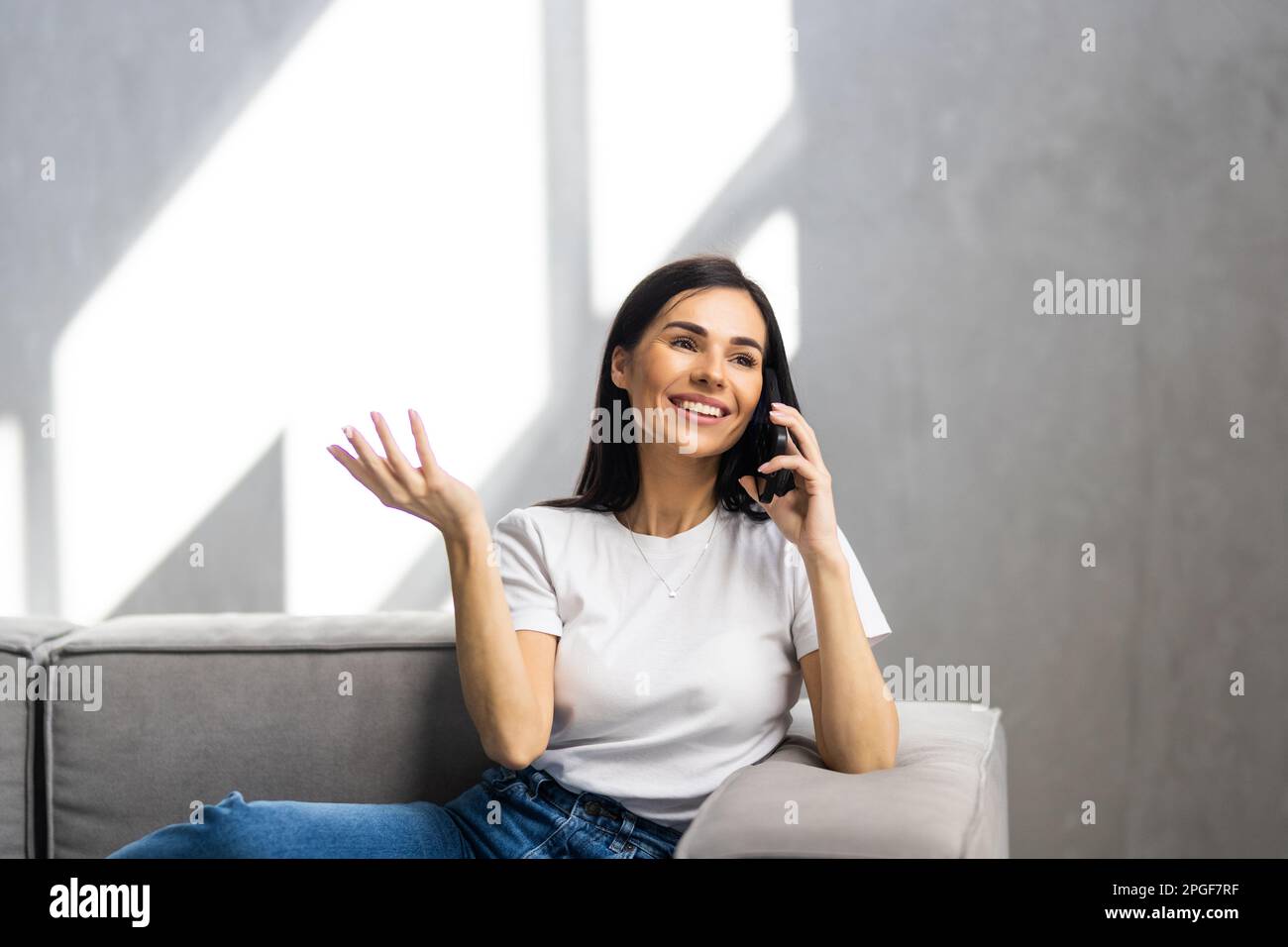 Happy young woman caller talking on the phone at home, cheerful teen ...