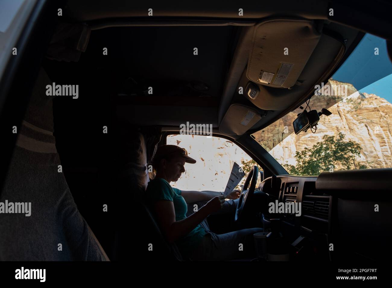 Young woman in van reading Zion National Park map in Utah Stock Photo ...