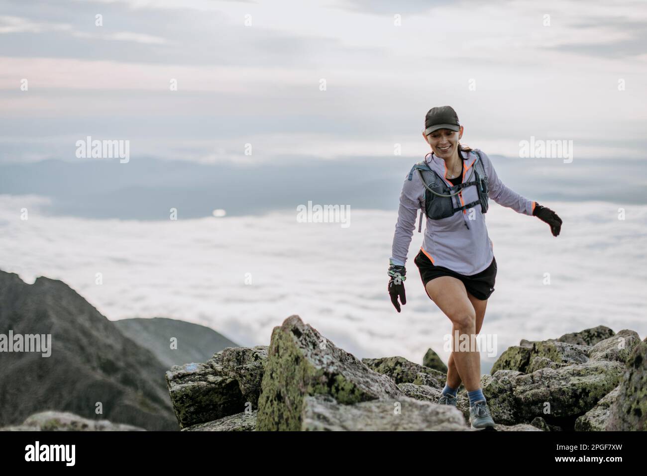 female hiker walks among rocks at summit of Mount Katahdin, Maine Stock ...