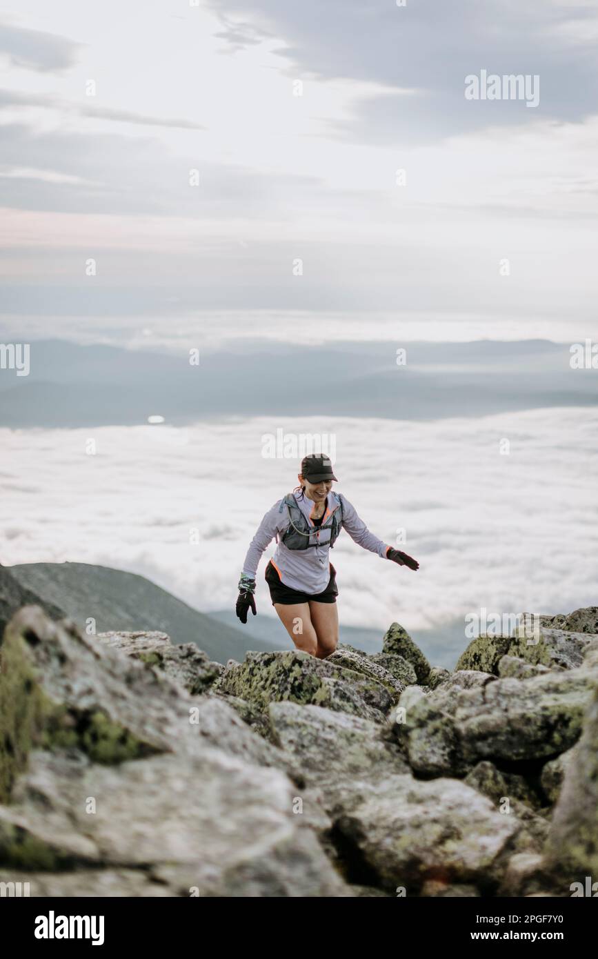young woman trail runner hikes along rocks of Katahdin, Maine Stock ...