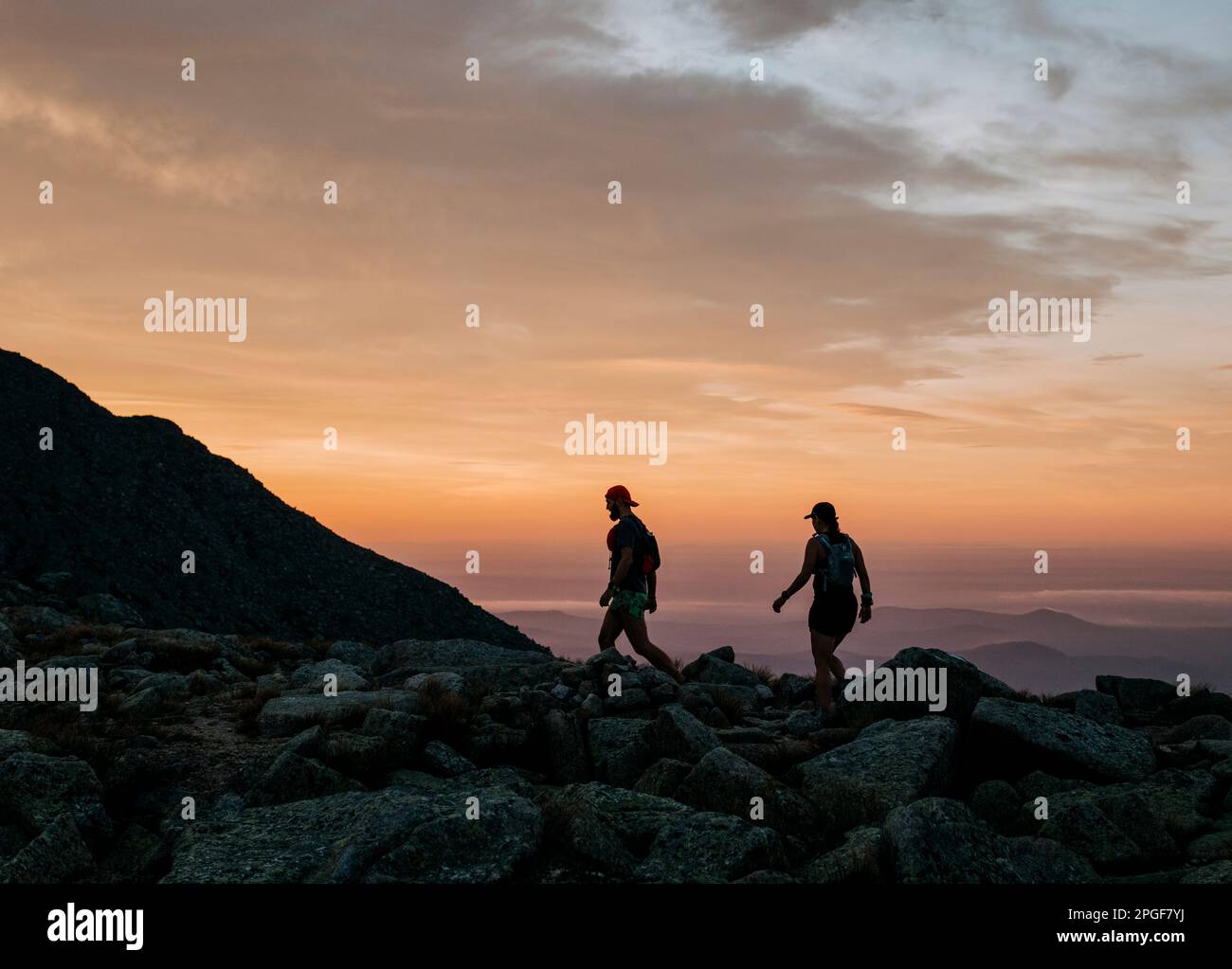 Two hikers walk along the top of Katahdin at dawn Stock Photo - Alamy