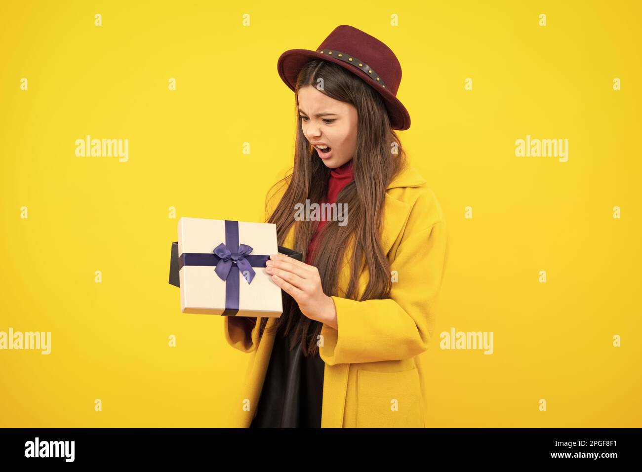 Emotional teenager child hold gift on birthday. Funny kid girl holding ...