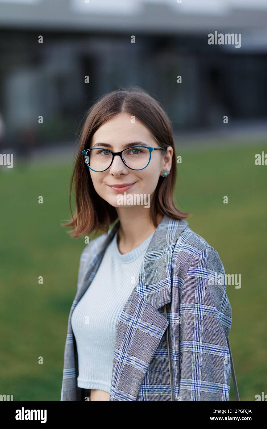 young female student in a jacket and jeans on campus Stock Photo - Alamy
