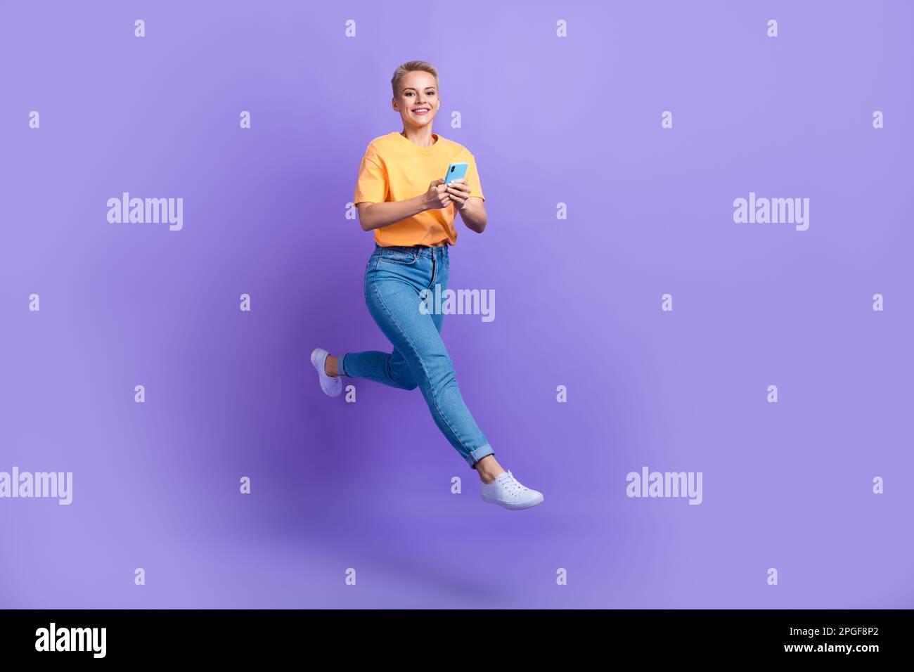 Full length profile photo of excited person jump rush hold telephone ...