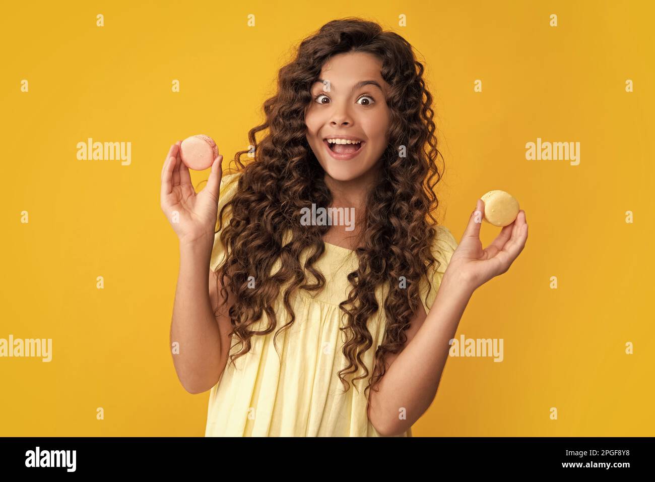 Child teen girl with dessert bakery. Teenager kid hold french macaron ...
