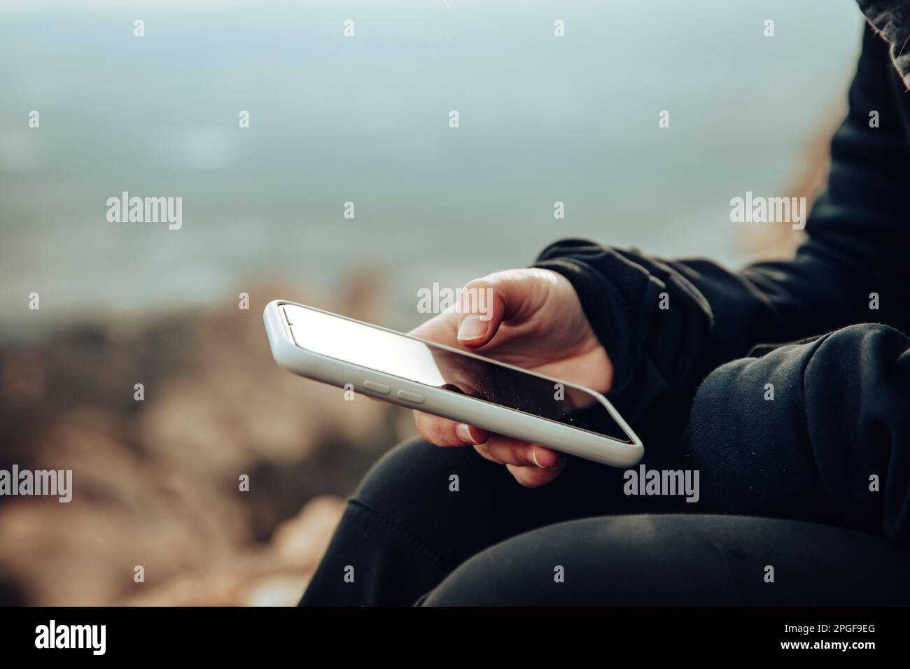Hand using a smartphone in nature. close up Stock Photo - Alamy
