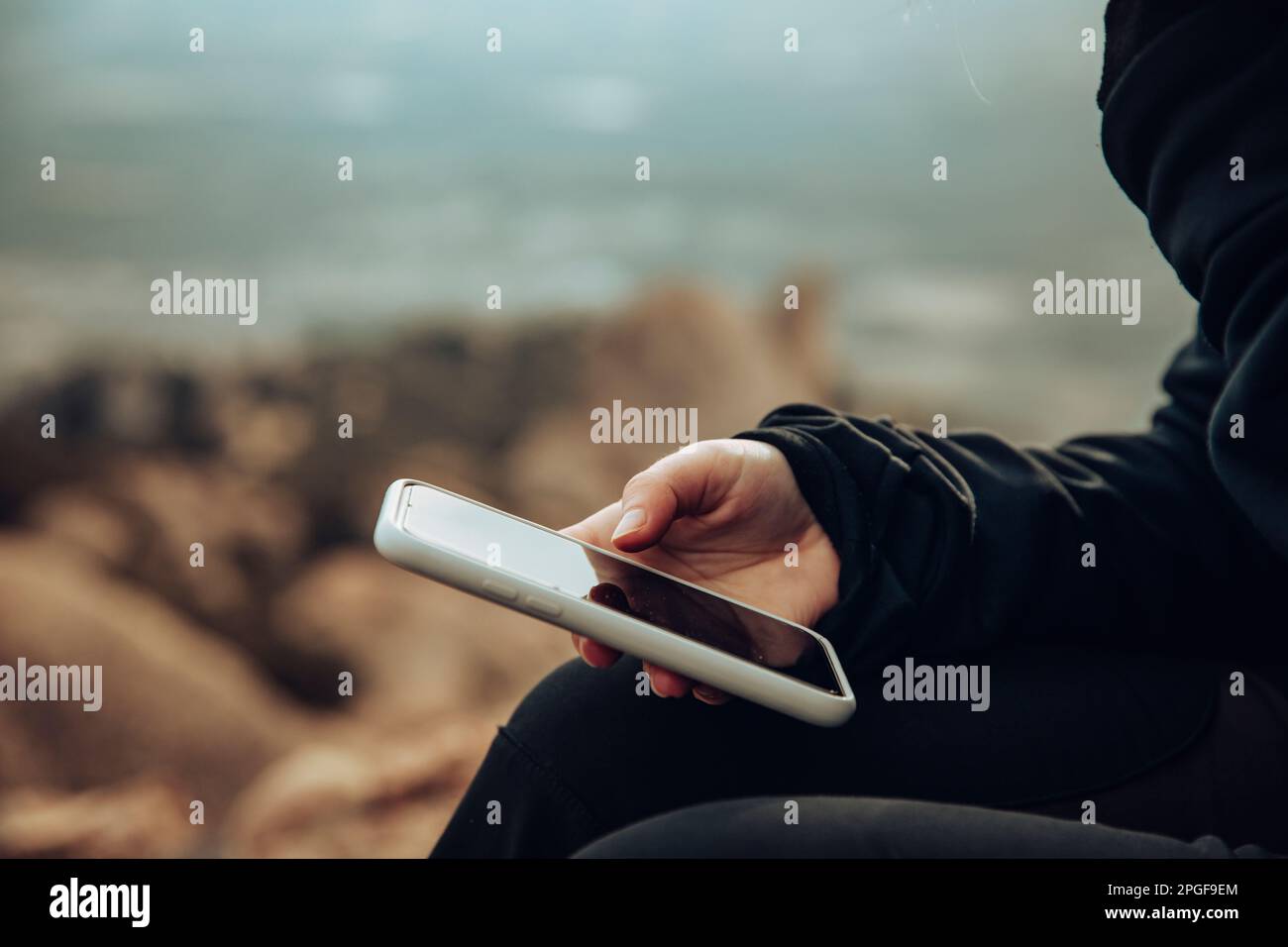 Hand using a smartphone in nature. close up Stock Photo - Alamy