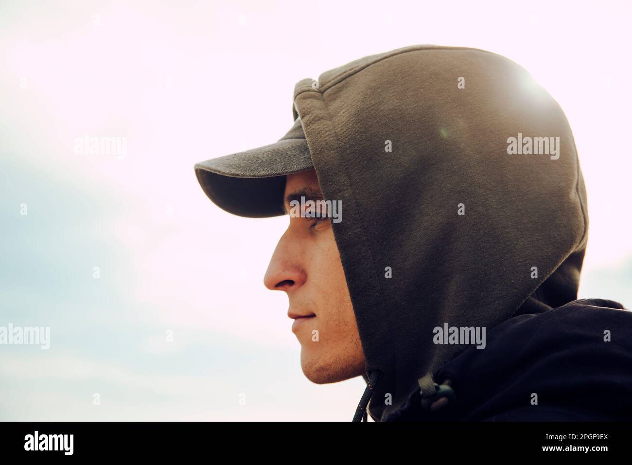 Boy with hood and cap from the side. Portrait Stock Photo - Alamy