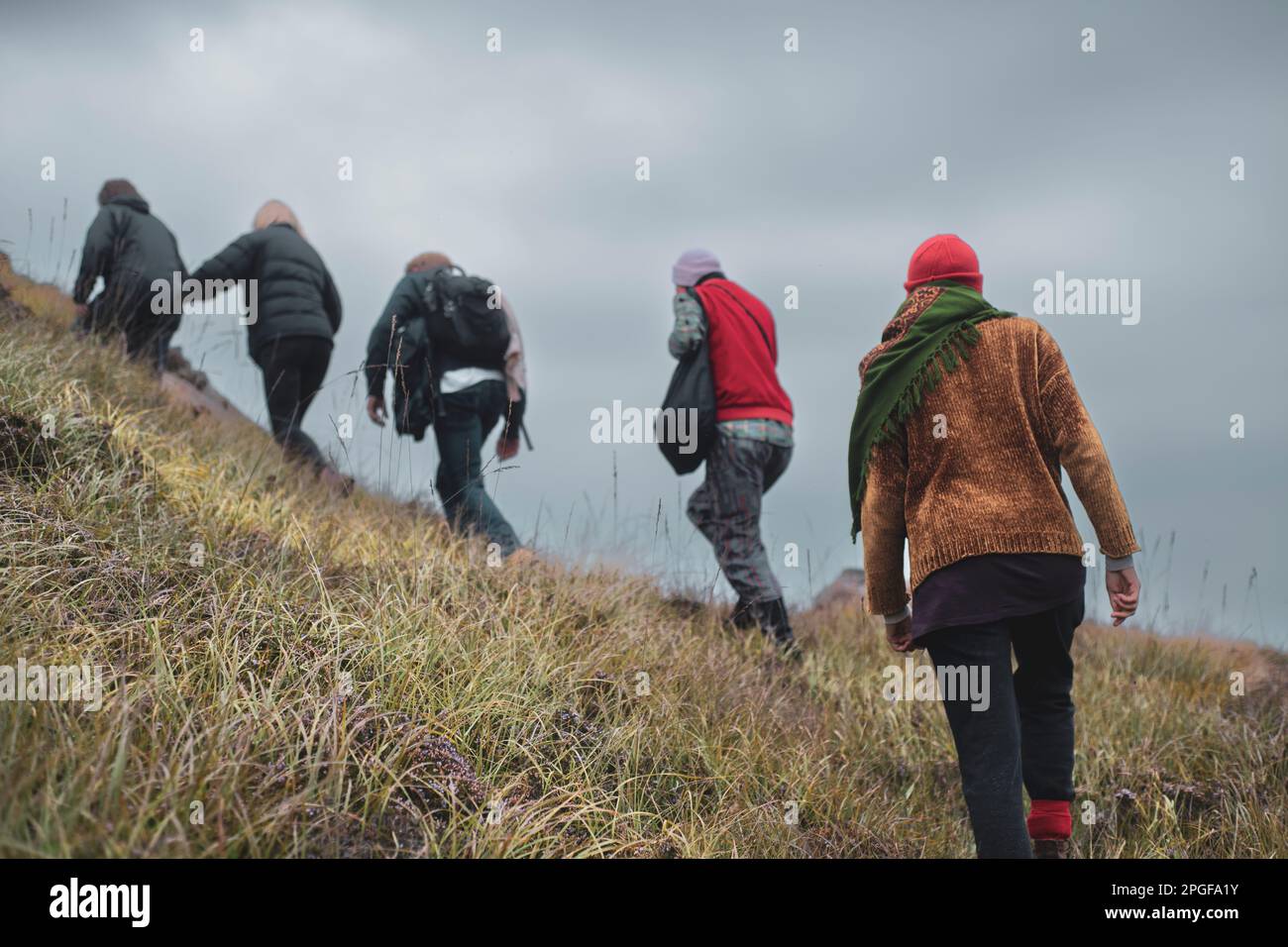 Group of friends hike up steep wild mountain slope in Scotland Stock ...