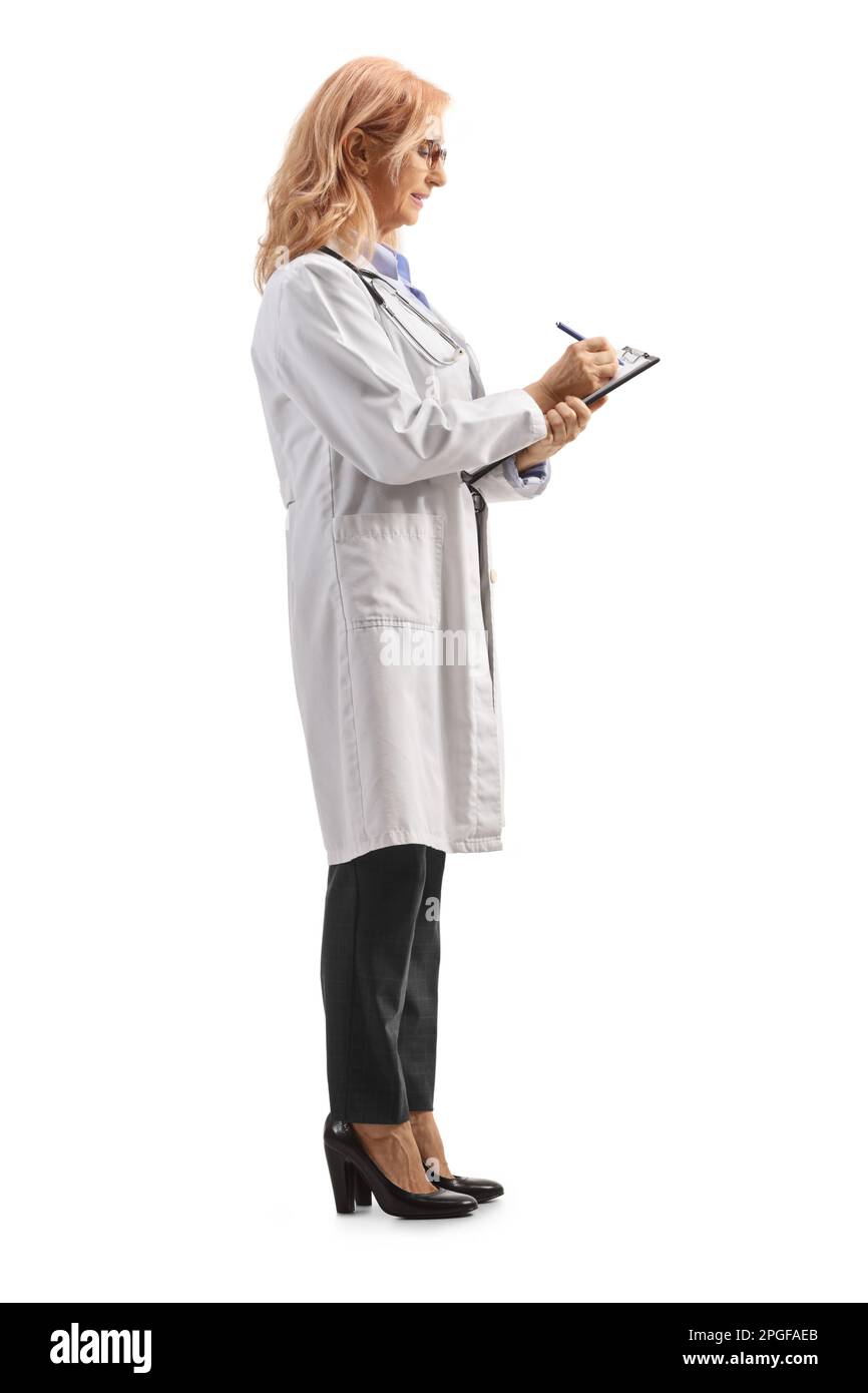 Full length profile shot of a female doctor standing and writing a ...