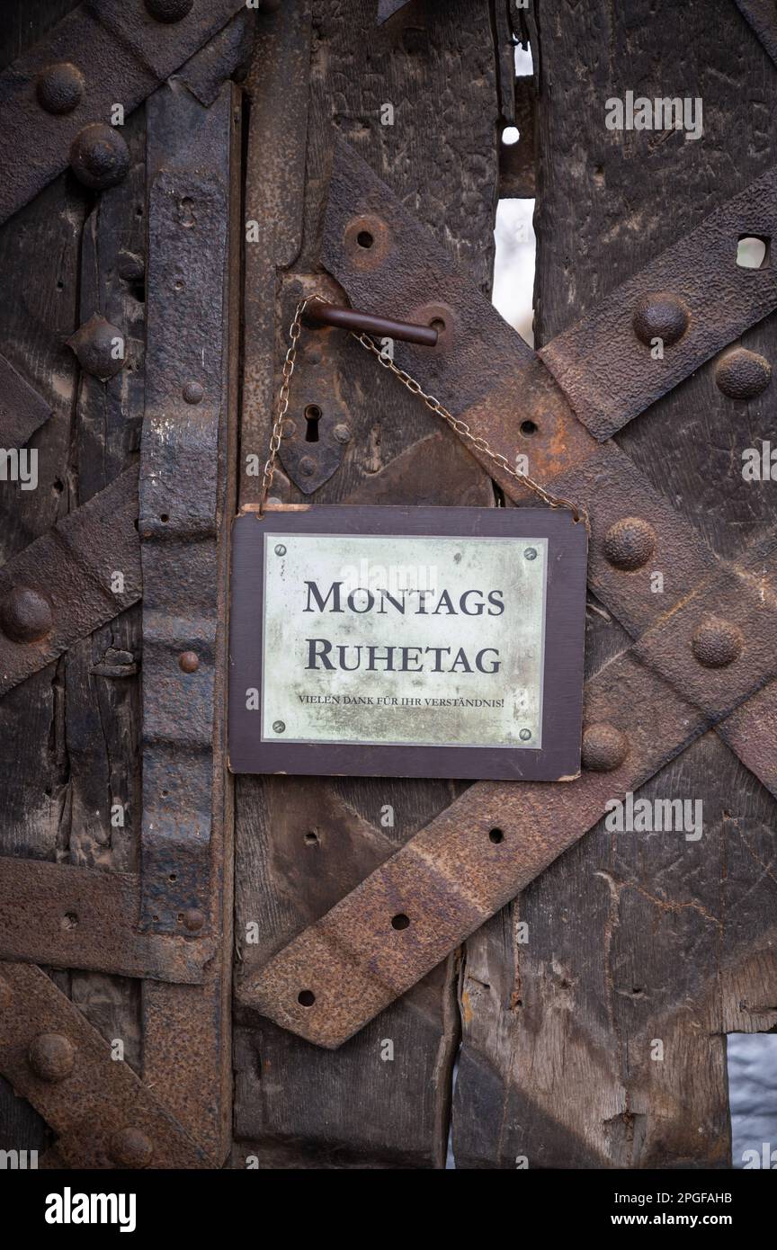 German Montags Ruhetag, Monday rest day sign at the metal wooden castle ...