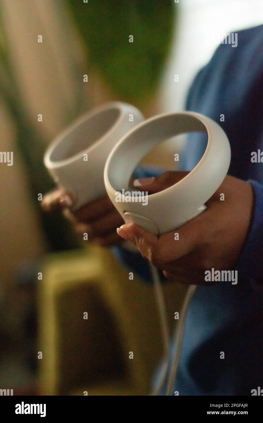 New technology teenager playing VR headset holding controllers Stock ...