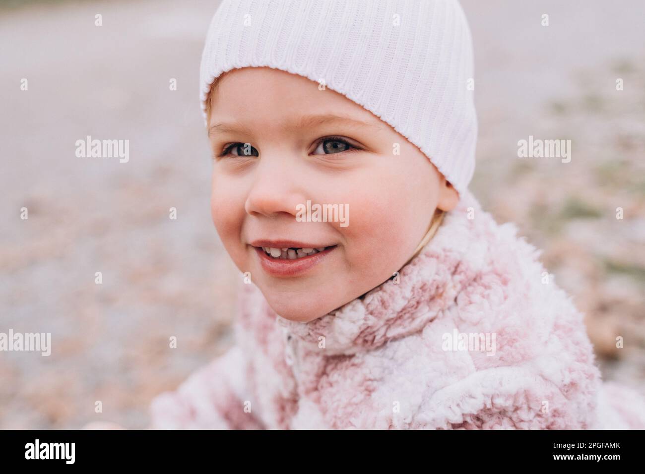 Toothless baby girl blonde caucasian in a hat smiling Stock Photo - Alamy