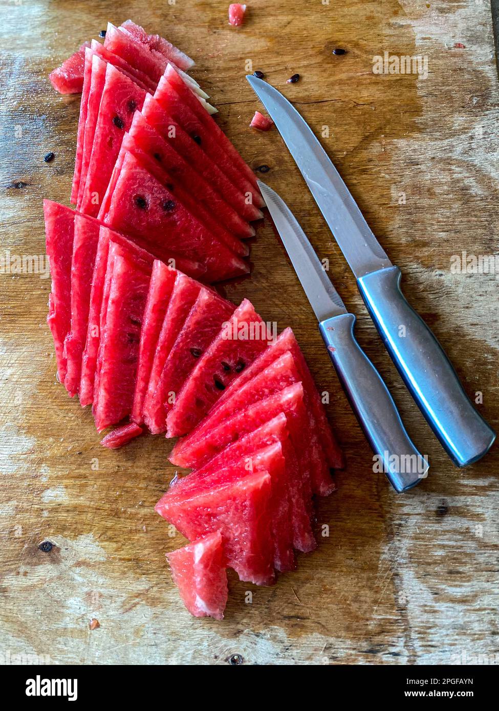watermelon sliced ??on a board with knives Stock Photo - Alamy