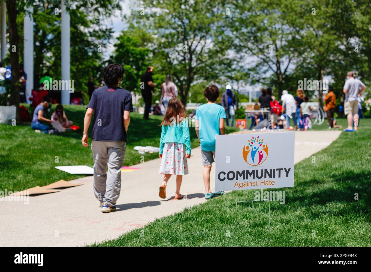 A father and children walk towards group of people at protest Stock ...