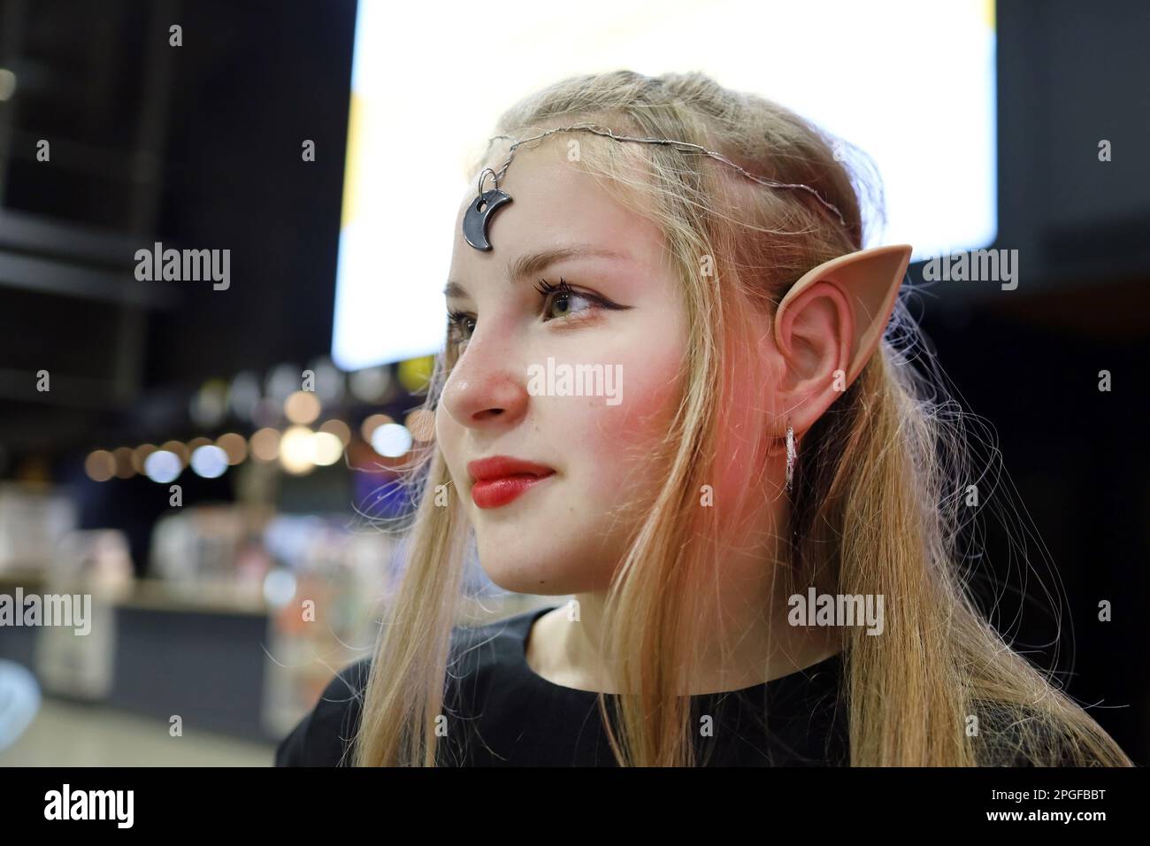 A teenage girl in the image of an elf at a movie night party Stock ...
