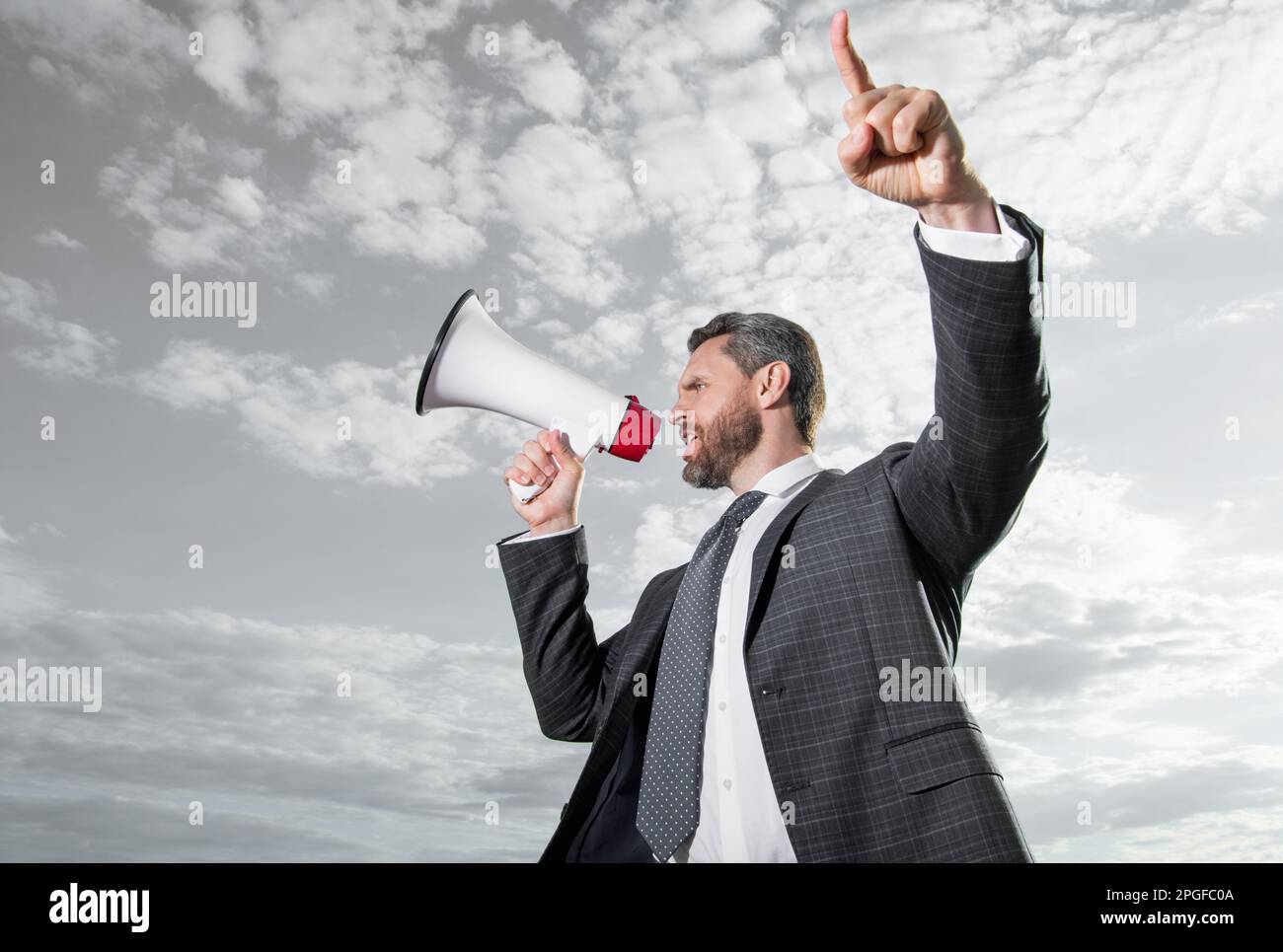 businessman shout in loudspeaker on sky background. attention Stock ...