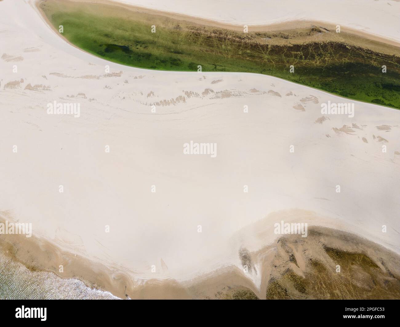Beautiful aerial view to white sand dunes and green rainwater pools ...