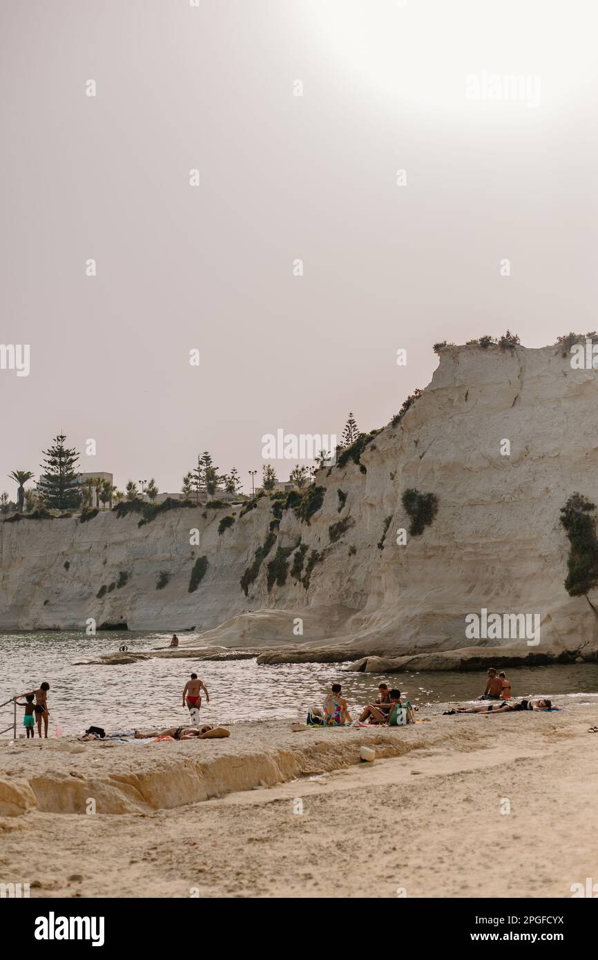Summer sunset swim at a local beach in Malta Stock Photo - Alamy