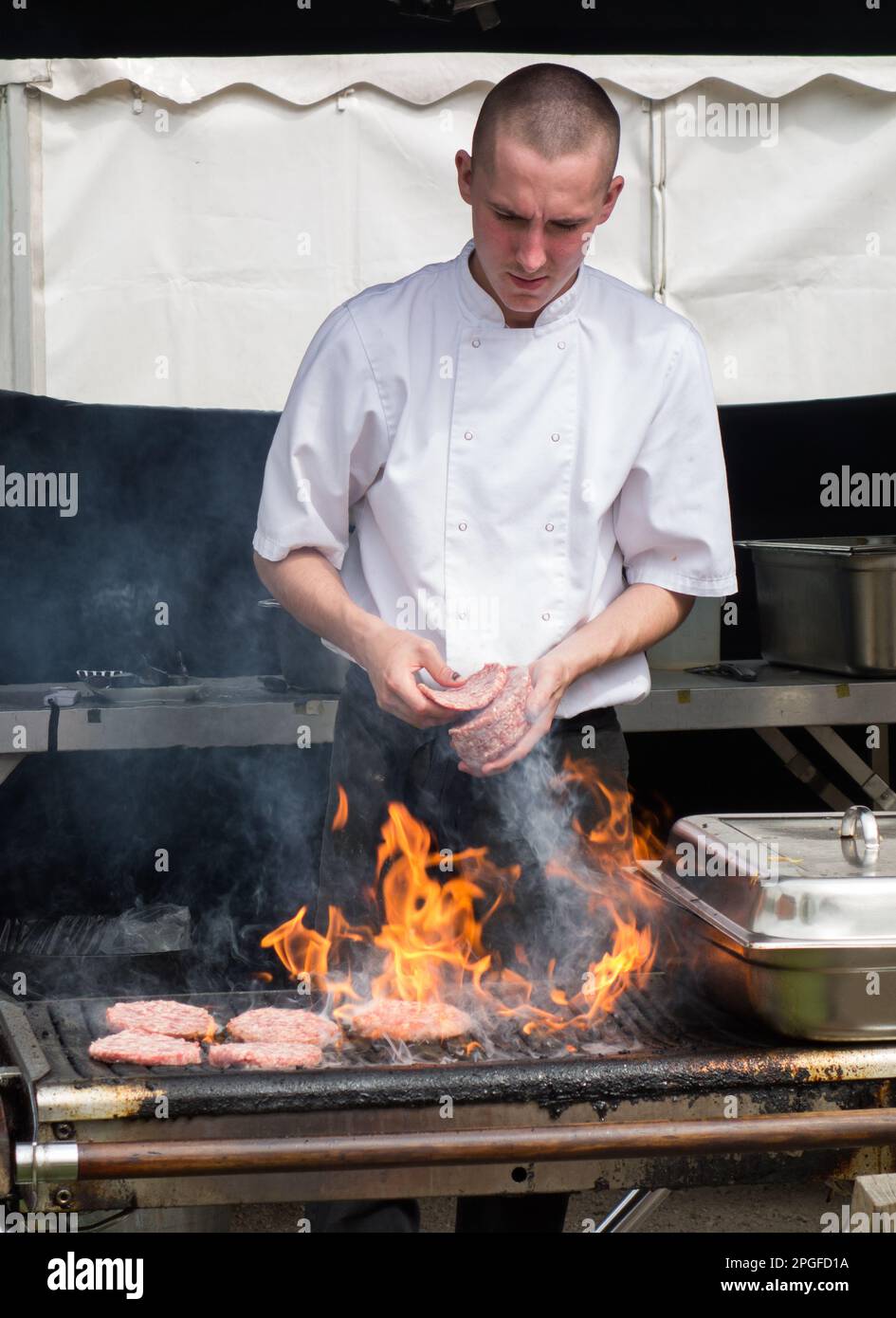 Colour Image Of A Chef Cooking On A Flame Grill With Flames Stock Photo ...