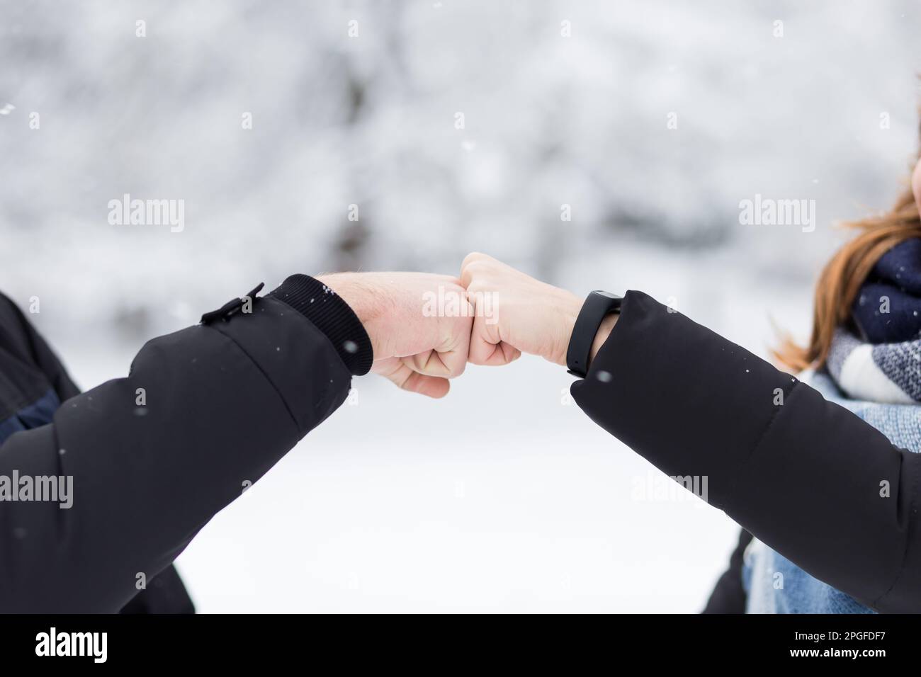 man and a woman clap their hands against of a snowy park Stock Photo ...