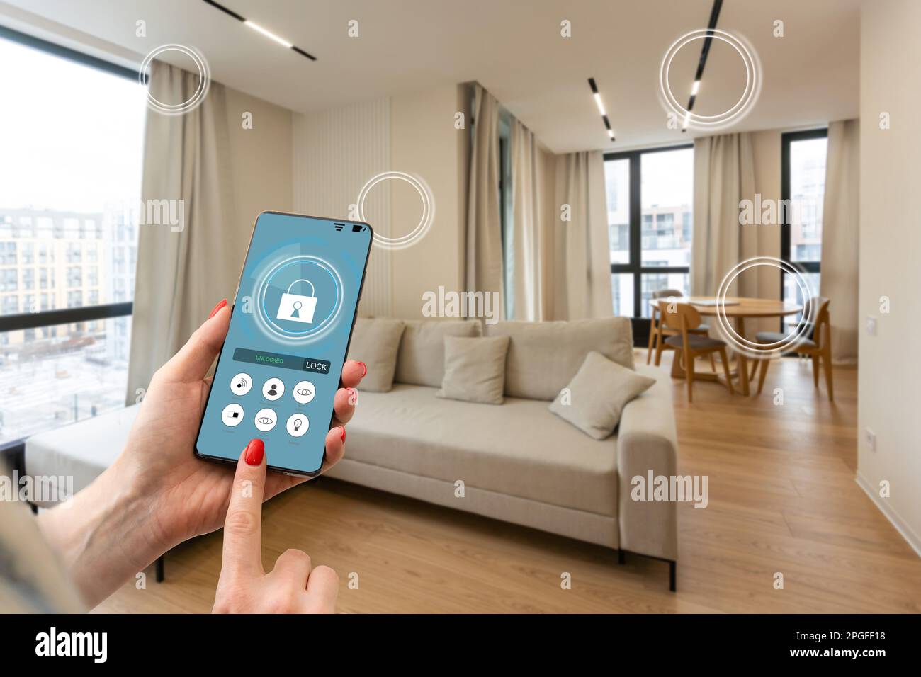 All the house in a phone. Close up of young woman user hands ...