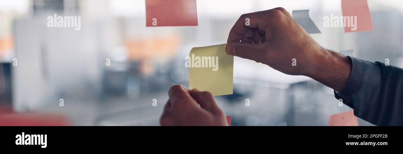 Businesswoman hand's is sticking sticky notes on motivation board in ...