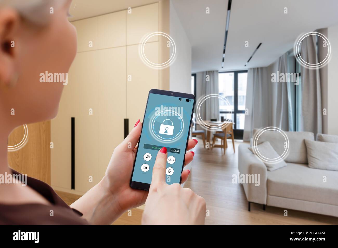 Close up smartphone in female hand with smart home system app interface ...