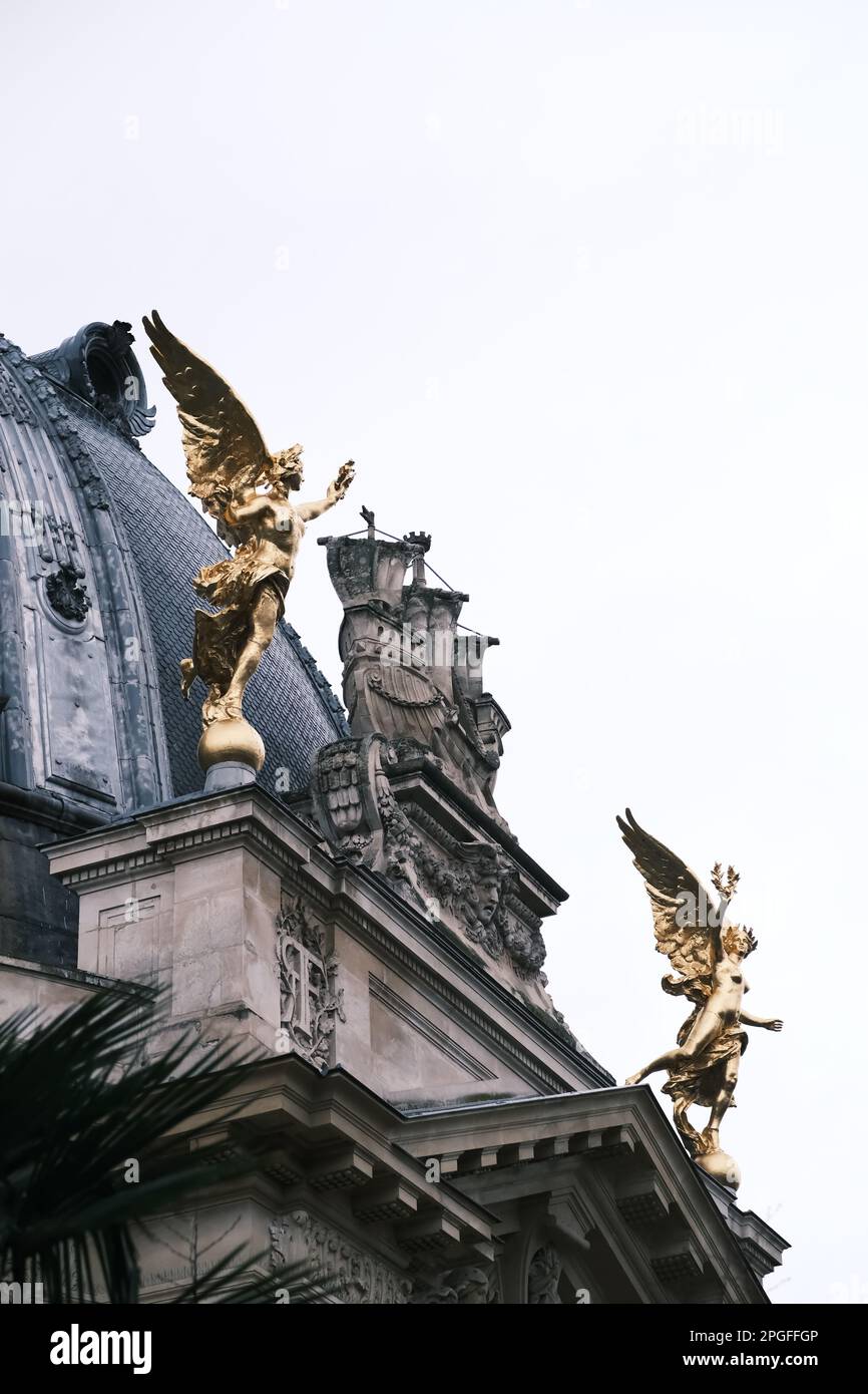 A vertical image of an impressive structure featuring intricate golden ...