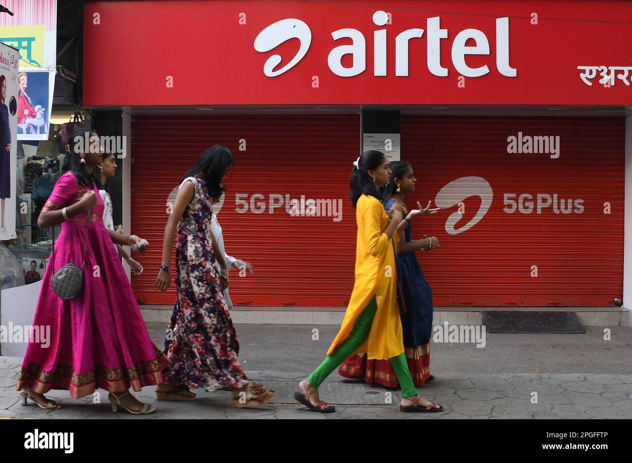 People walk past the Airtel store in Mumbai. Airtel is offering ...