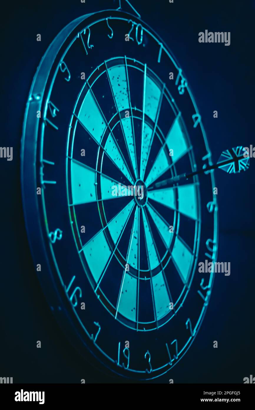A vertical shot of a dartboard with a bullseye in the centre ...