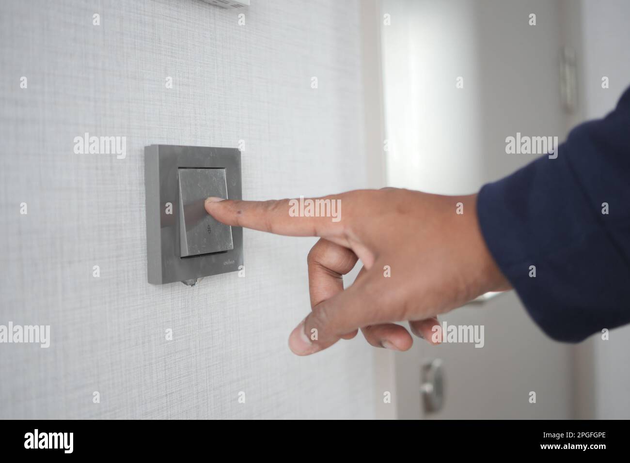 A finger turning on lighting switch Stock Photo - Alamy