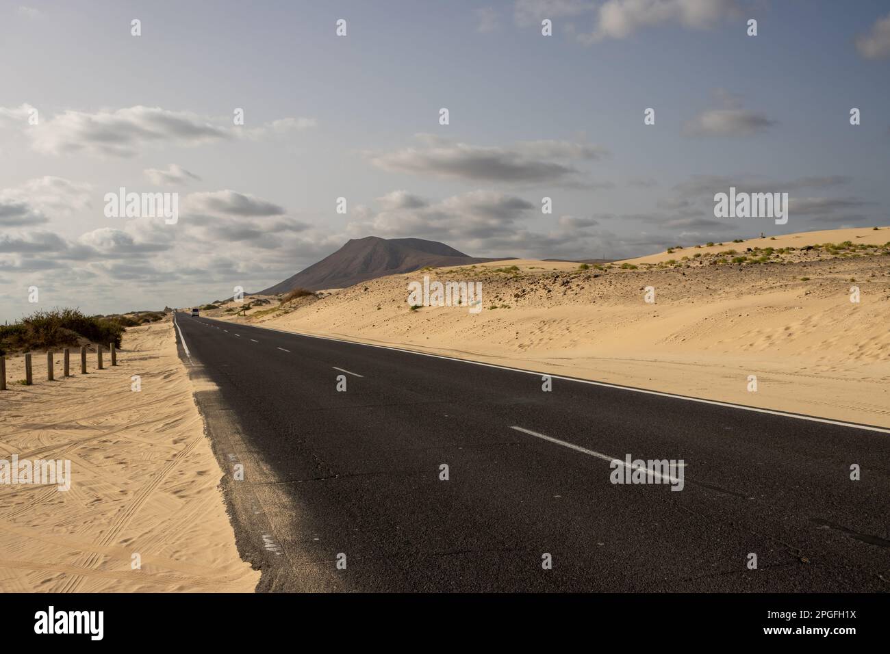 Good quality of the road through the desert. Sand of the dunes on both ...