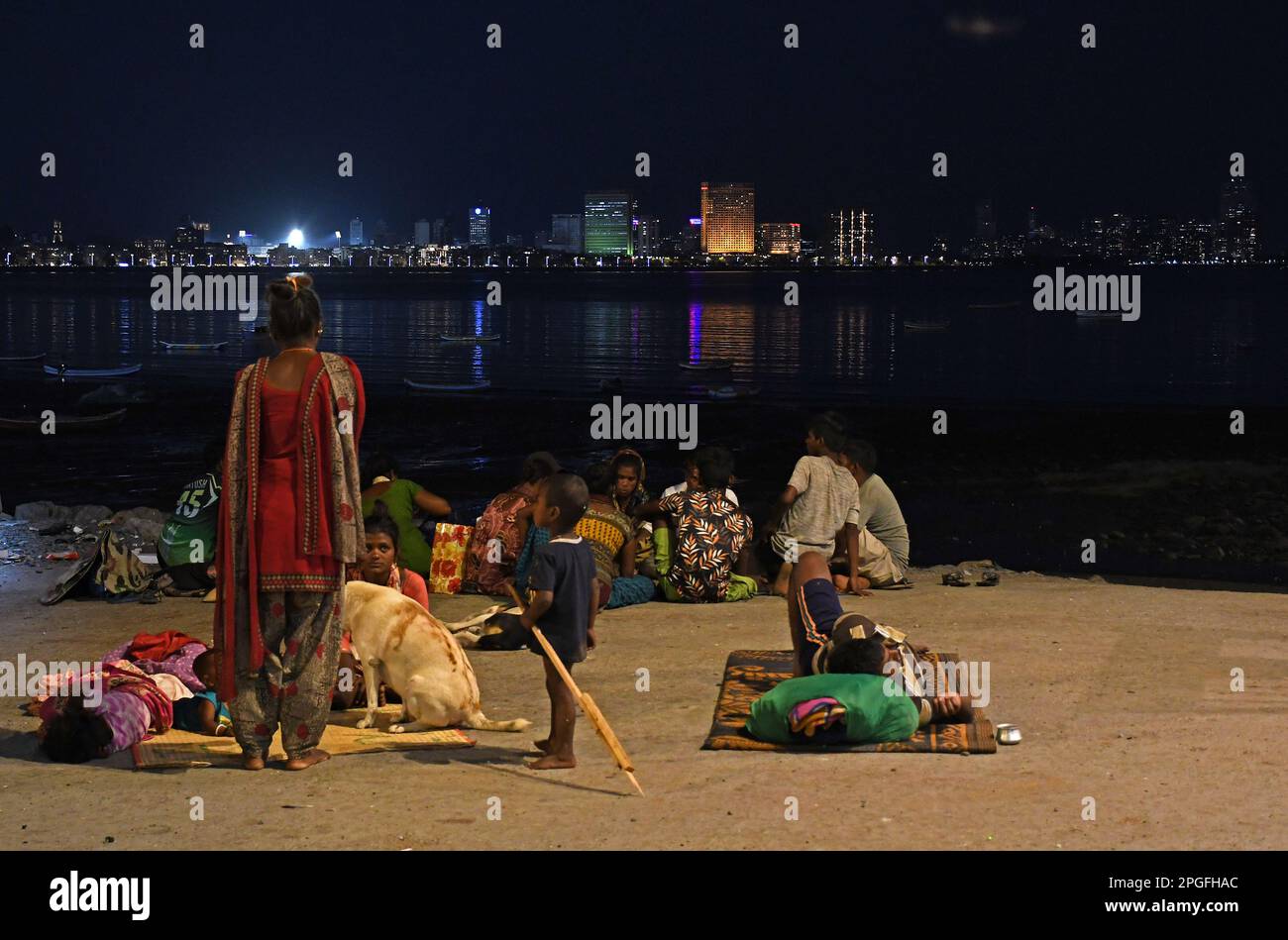 Mumbai, India. 21st Mar, 2023. Homeless people are seen on the beach as ...