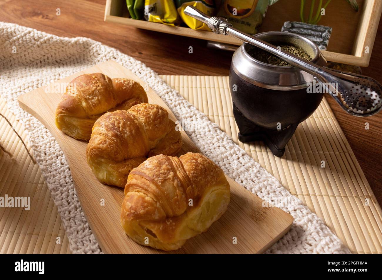 Argentinian breakfast. Croissants and mate with empty packets of yerba ...