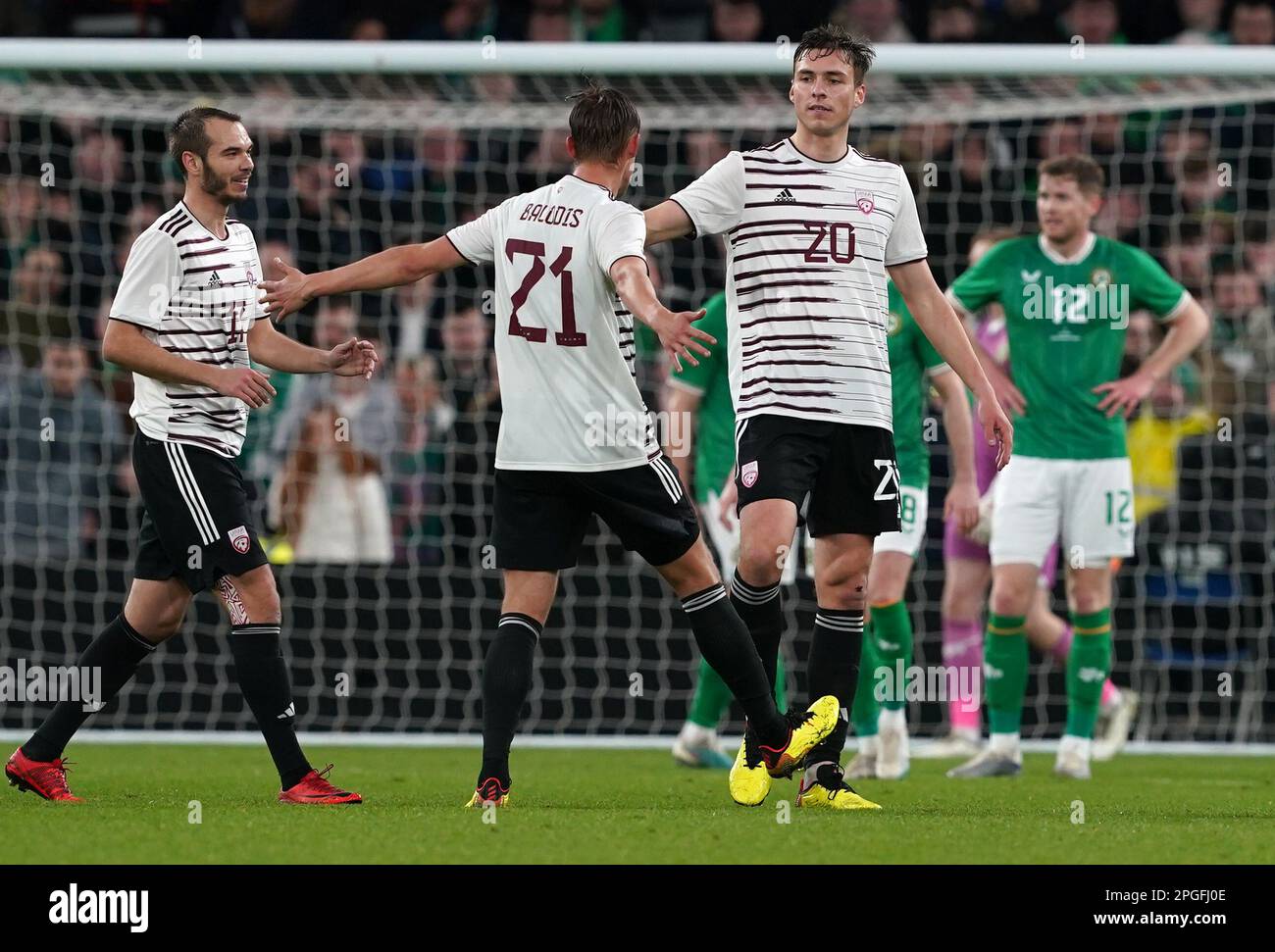 Latvia's Roberts Uldrikis (right) celebrates scoring his sides first ...