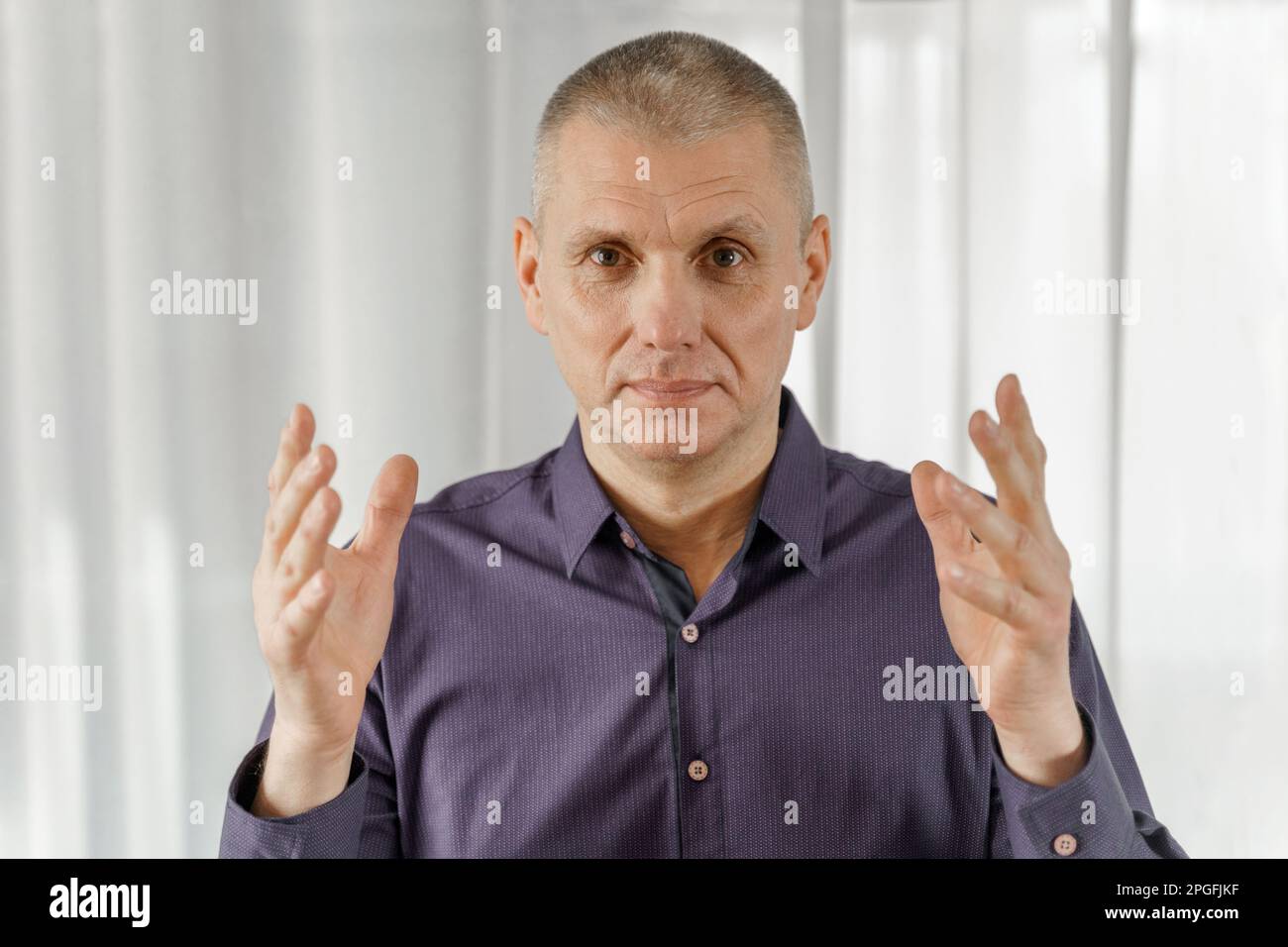 The male manager addresses the audience using hand gestures to attract ...