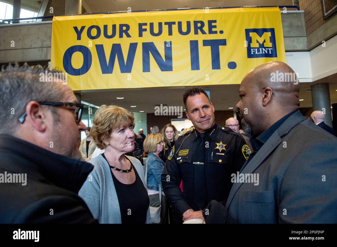 Genesee County Sheriff Christopher Swanson, second from right, listens ...