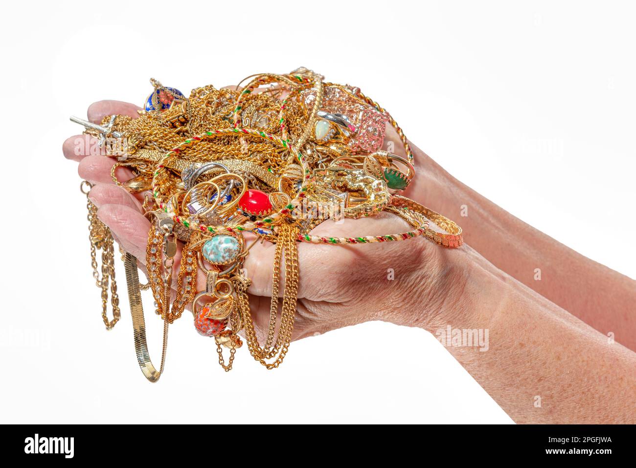 Horizontal shot of a two hands holding gold jewelry on a white ...