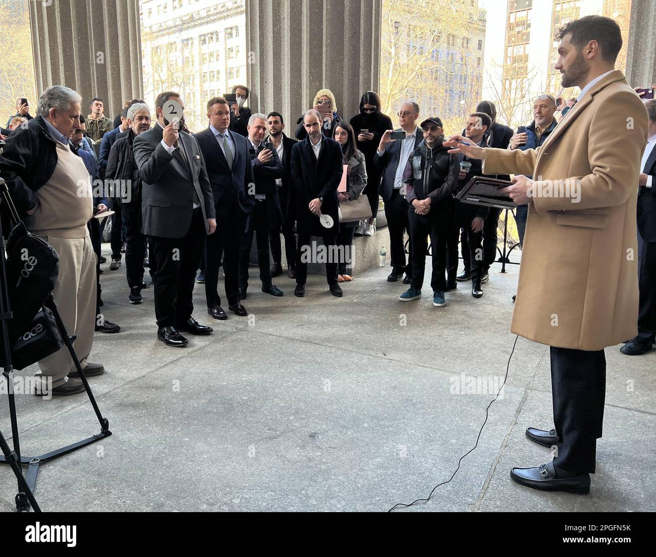 New York, USA. 22nd Mar, 2023. Auctioneer Matthew D. Mannion (r), in ...