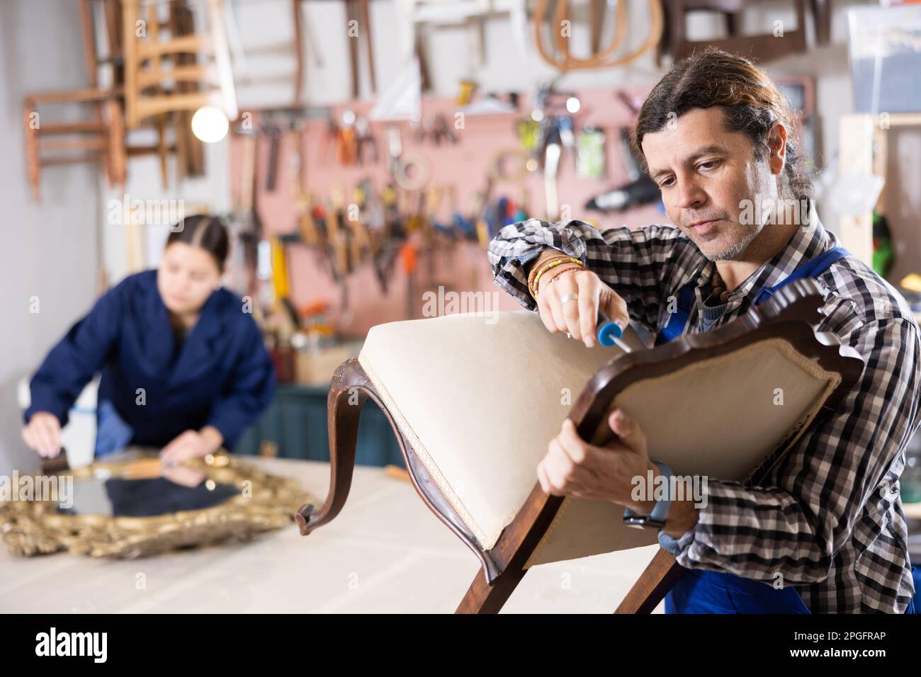 Male furniture workshop worker designing vintage chair Stock Photo - Alamy