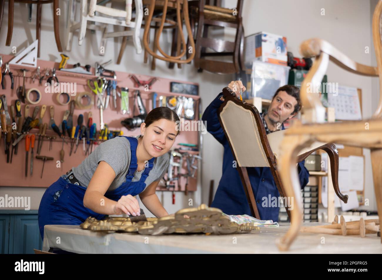 Portrait of skillful repair woman carpenter renovating mirror frame ...