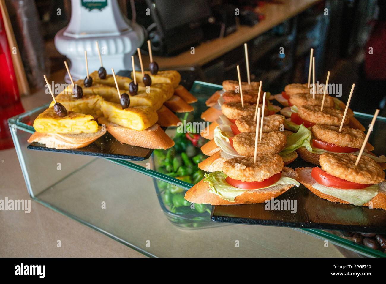 Tapas (pintxos, sandwich) with small chicken cutlet and slice of ...