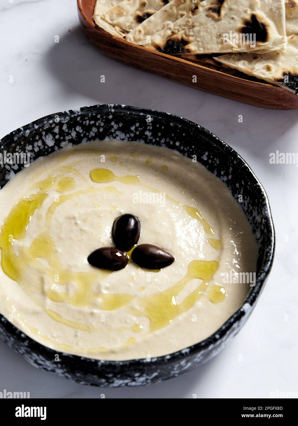 Taramasalata in the bowl with olive oil and black olive. Taramasalata ...