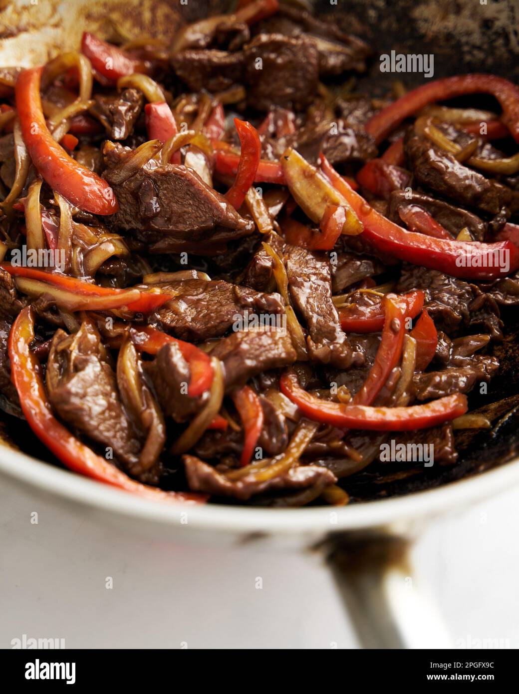 Chopped Hawaiian steak in wok with carrots and other vegetables. Sticky ...