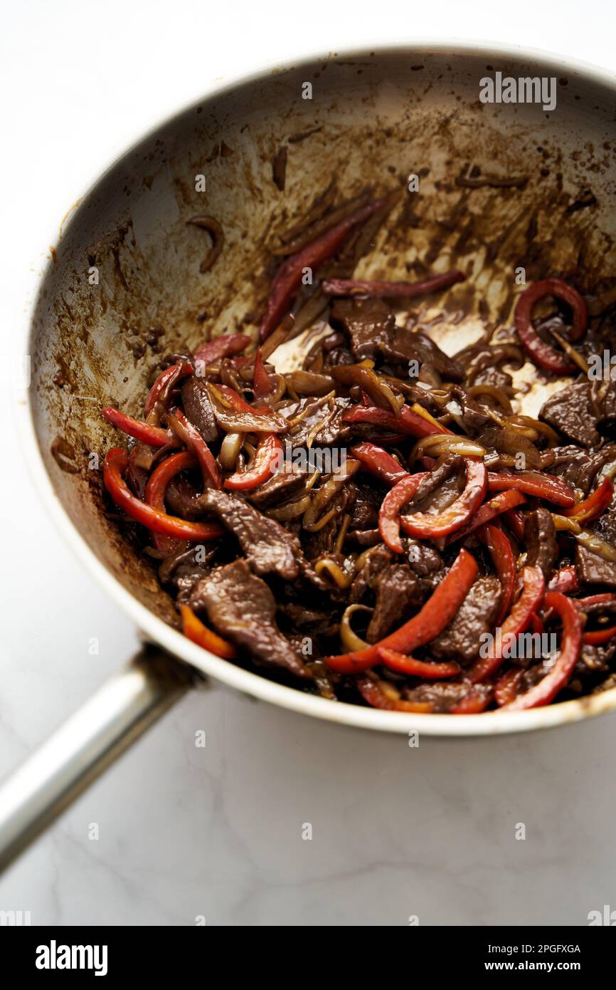 Chopped Hawaiian steak in wok with carrots and other vegetables. Sticky ...